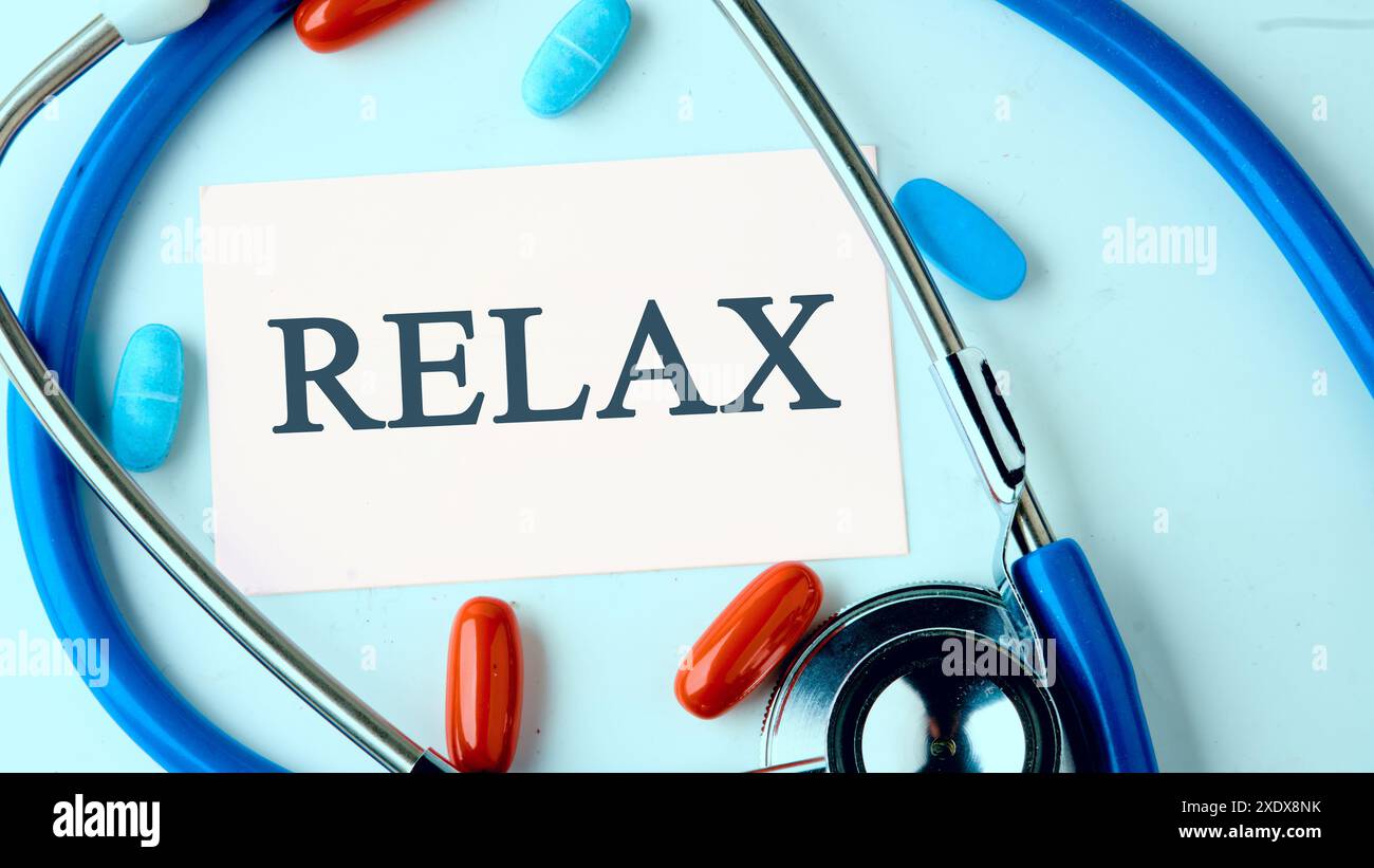 Relax Or Stress concept. RELAX written on a white business card on a ...