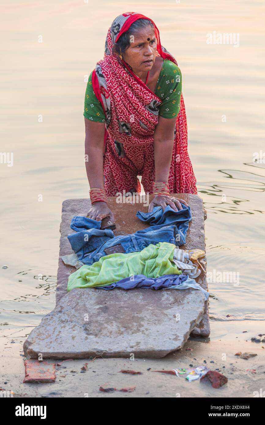 Indian woman washing clothes outside hi-res stock photography and ...