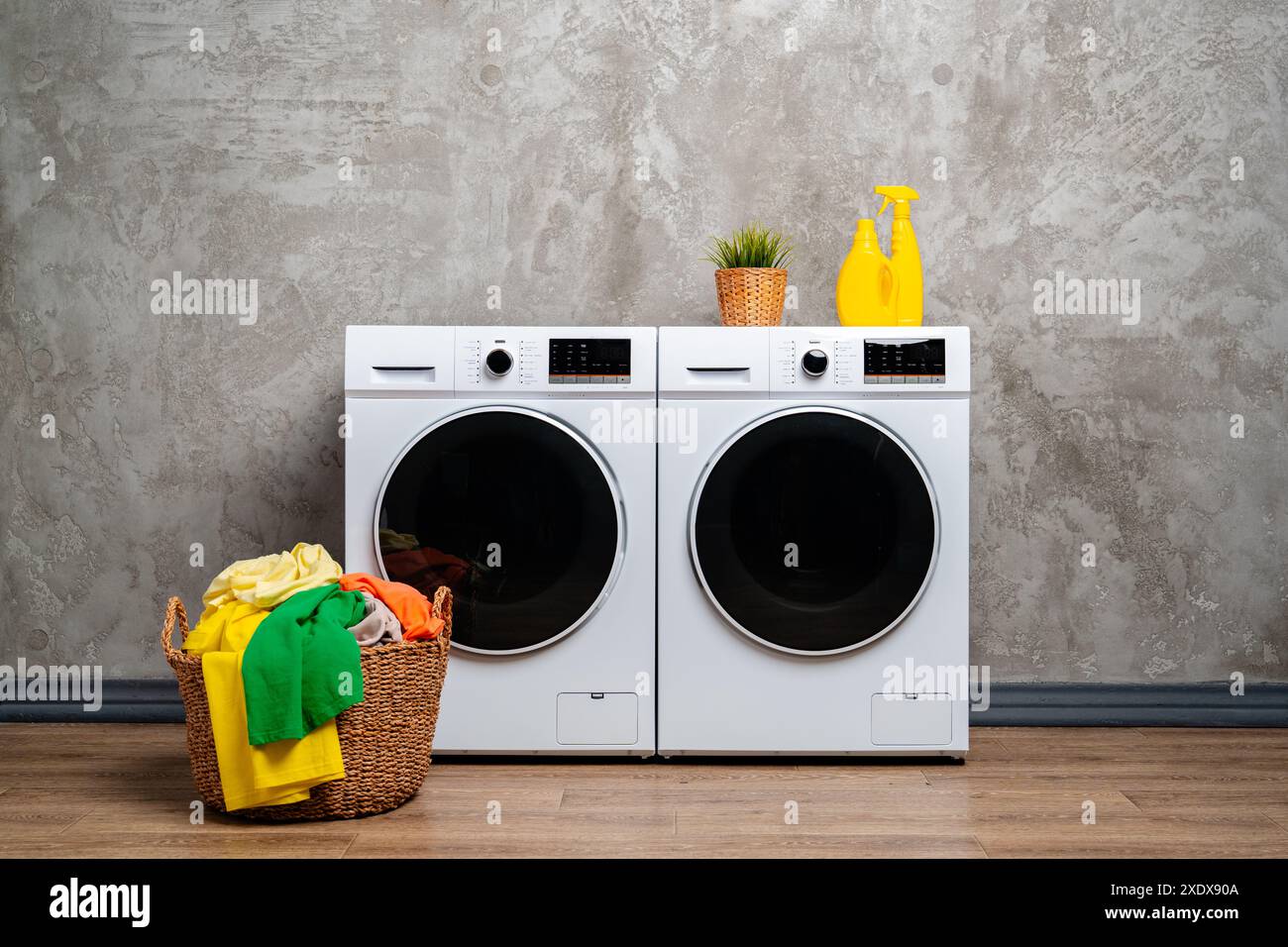 Modern White Washing Machines With Open Door and Laundry Basket in a ...
