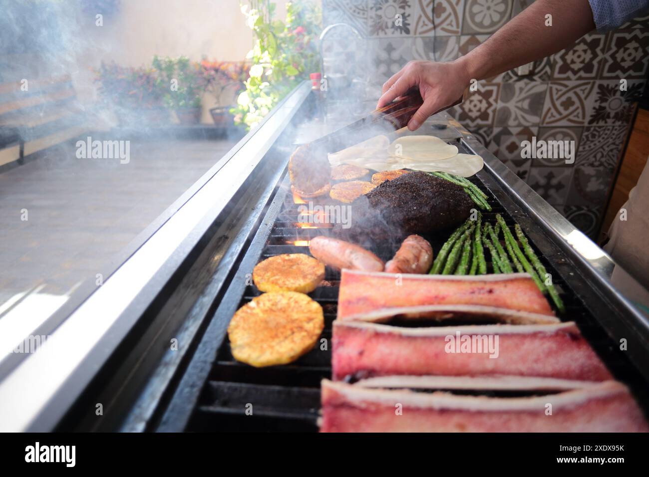 Man cooks mexican food on the grill Stock Photo - Alamy