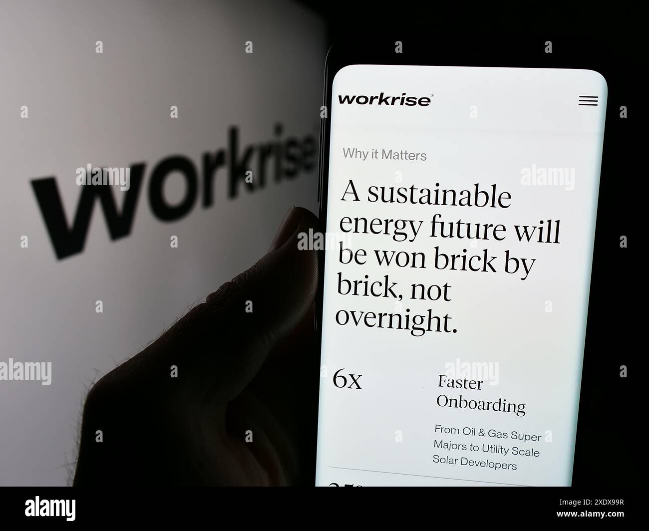 Person holding cellphone with website of US software company Workrise Technologies Inc. in front ...