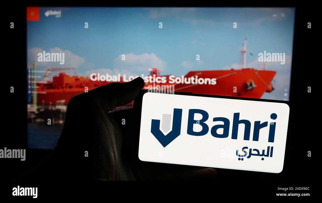 Person holding smartphone with logo of business National Shipping ...