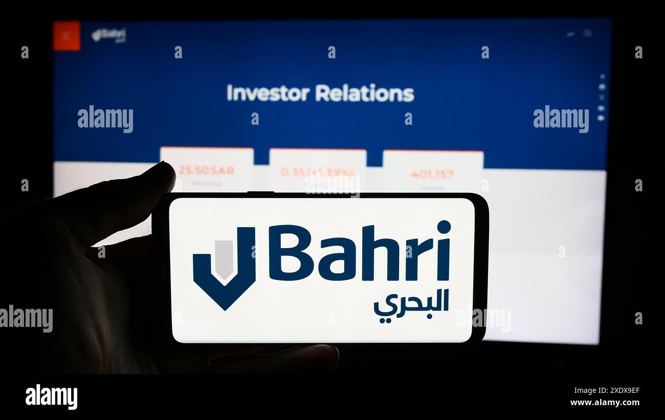 Person holding cellphone with logo of business National Shipping ...