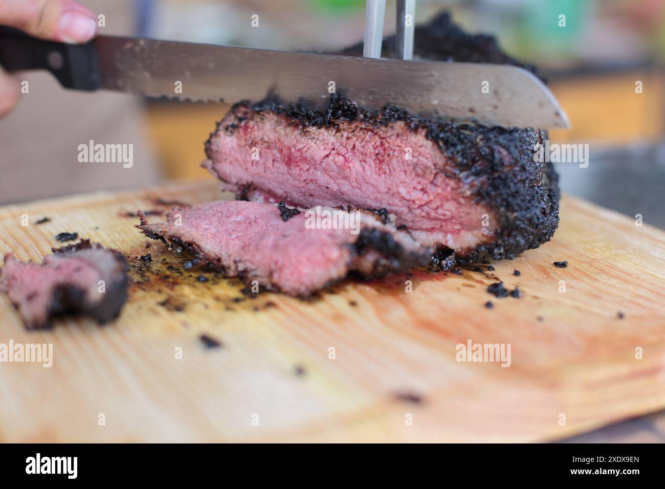 Cook cuts a piece of picanha into strips Stock Photo - Alamy