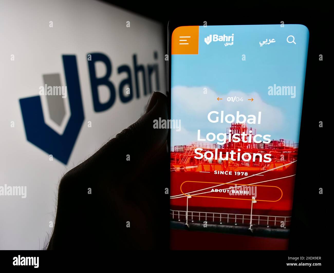 Person holding mobile phone with logo of business National Shipping ...