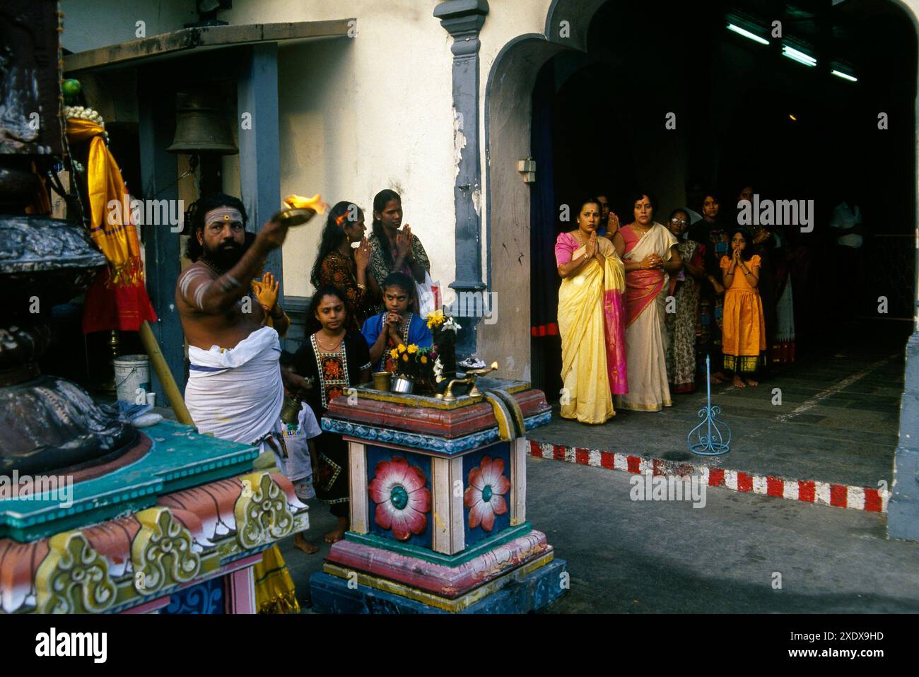 Priest with flame in dhoti conducting Deepavali ceremony, taken in 1994 ...