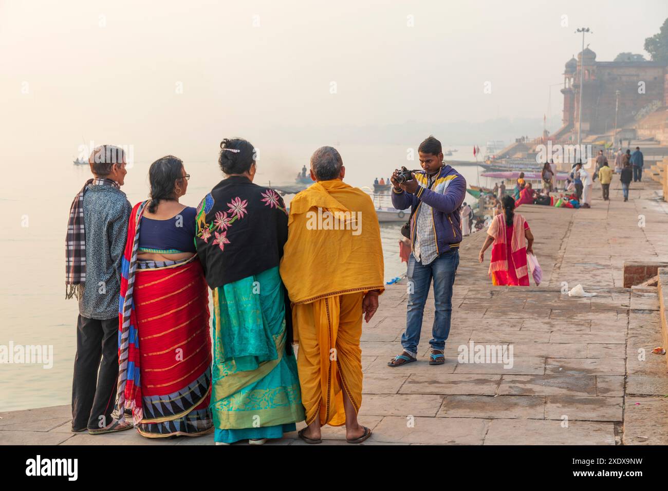 India, Uttar Pradesh, Varanasi. Man taking a family photo along the ...