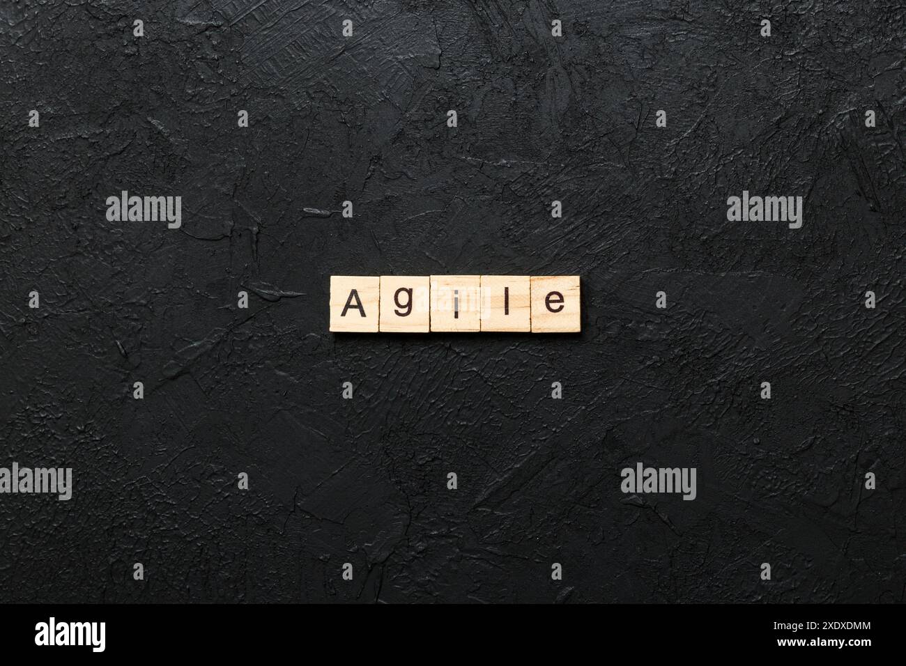 Agile word written on wood block. Agile text on cement table for your ...