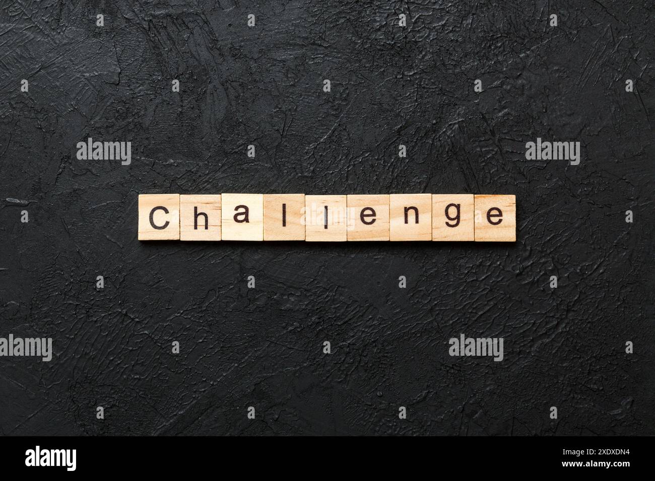CHALLENGE word written on wood block. CHALLENGE text on cement table ...