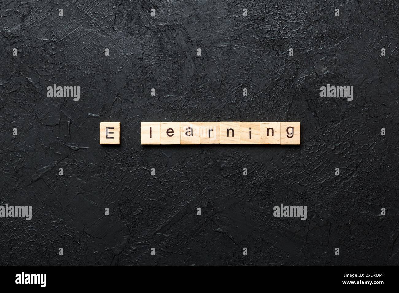 E learning word written on wood block. Elearning text on cement table ...