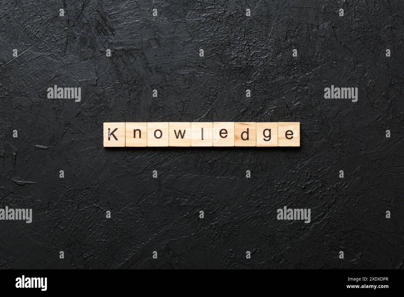 Knowledge word written on wood block. Knowledge text on cement table ...