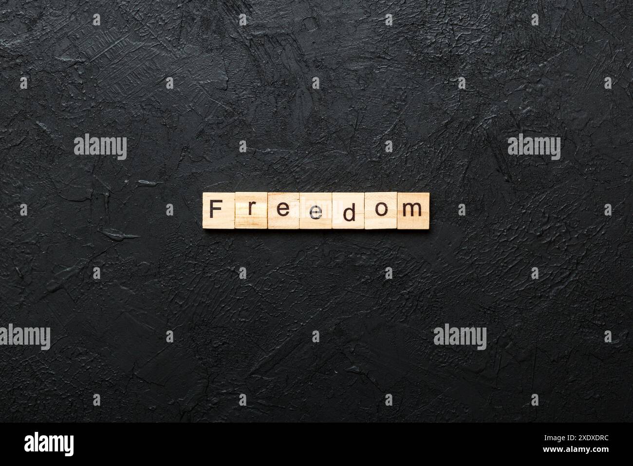 Freedom word written on wood block. Freedom text on cement table for ...