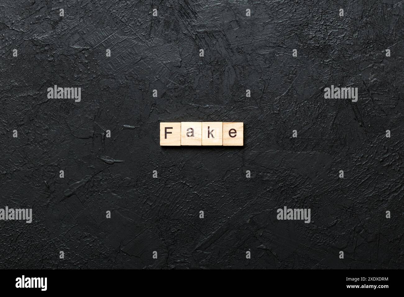 Fake word written on wood block. Fake text on cement table for your ...