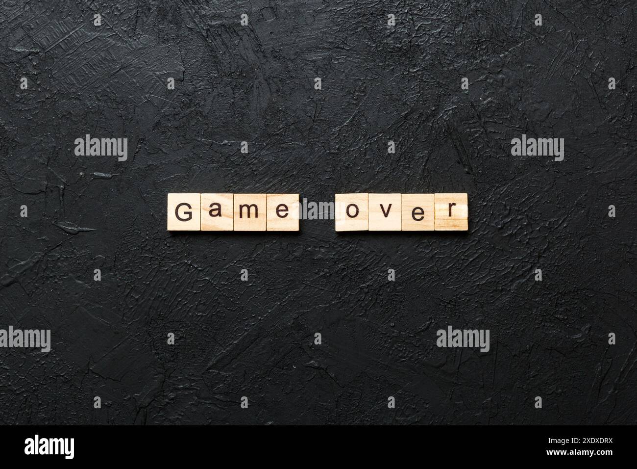 game over word written on wood block. game over text on table, concept ...
