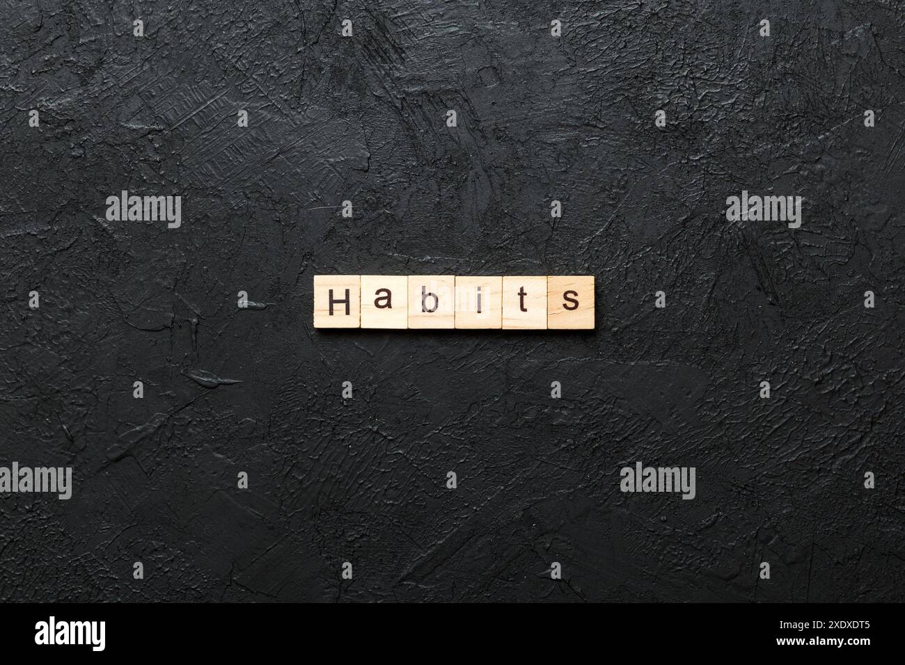 HABITS word written on wood block. HABITS text on cement table for your ...