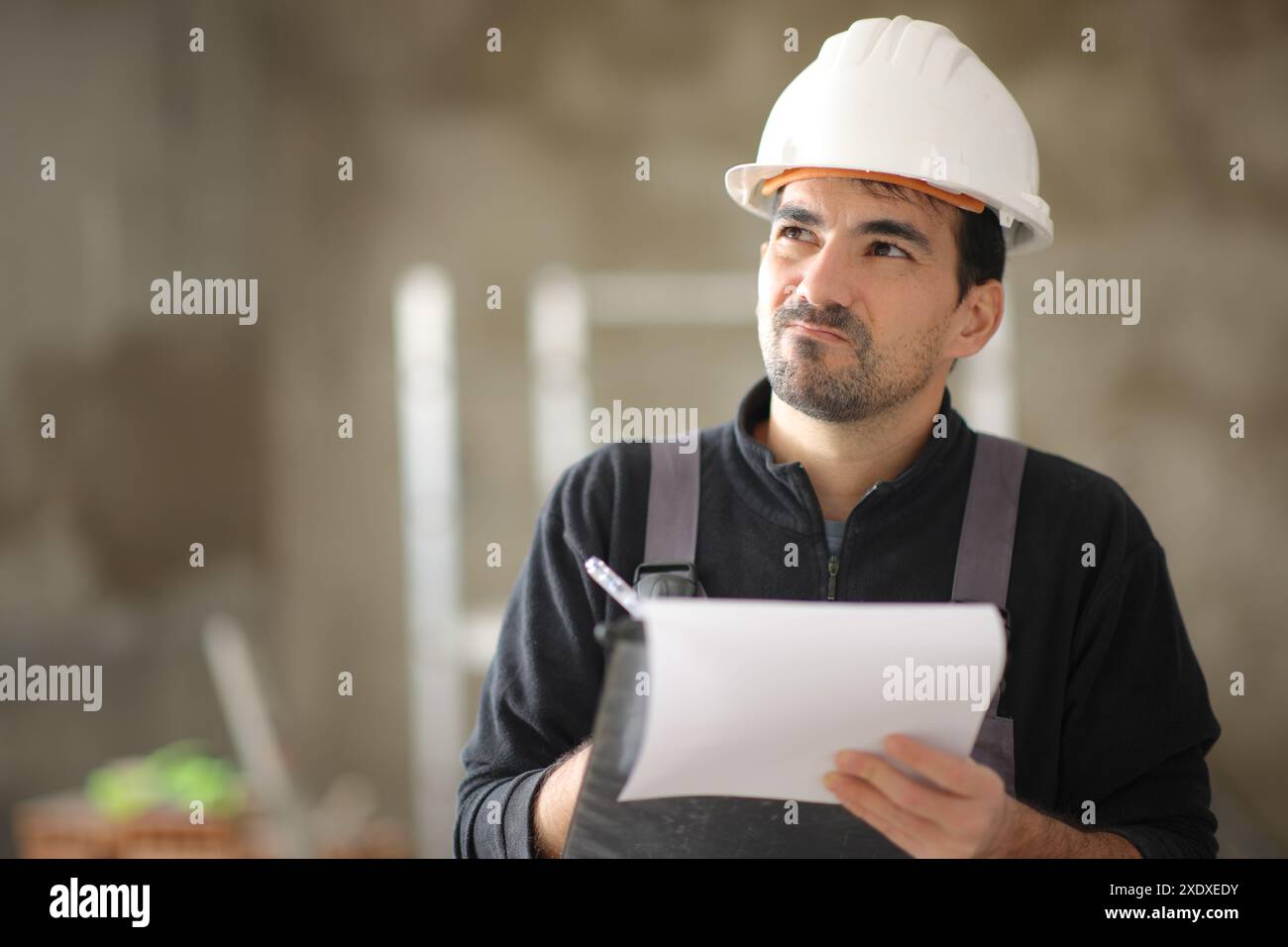 Disappointed construction worker checking work taking notes looking ...