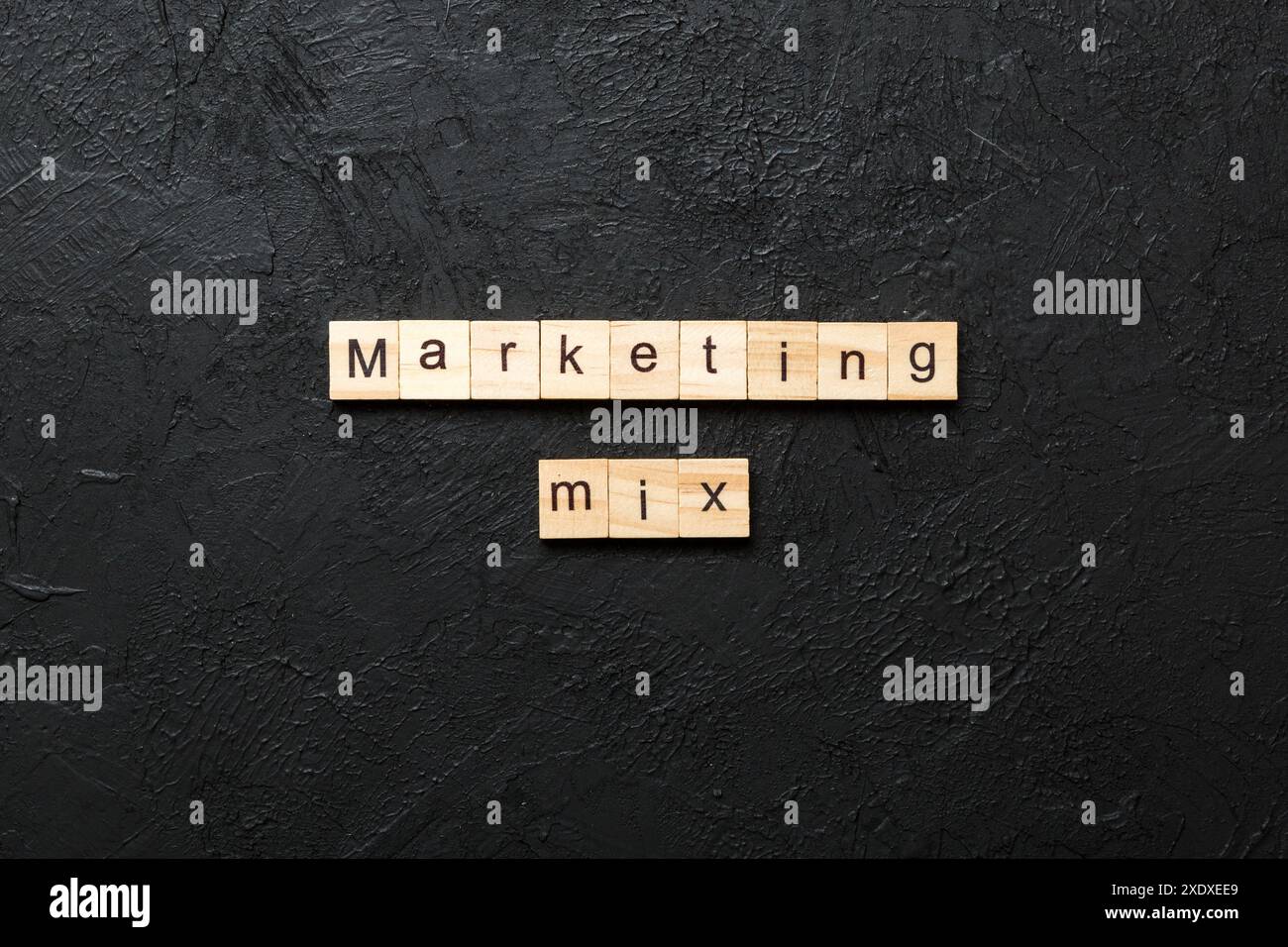 MARKETING MIX word written on wood block. MARKETING MIX text on cement ...