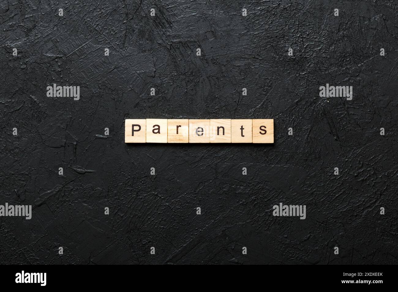 Parents word written on wood block. Parents text on cement table for ...