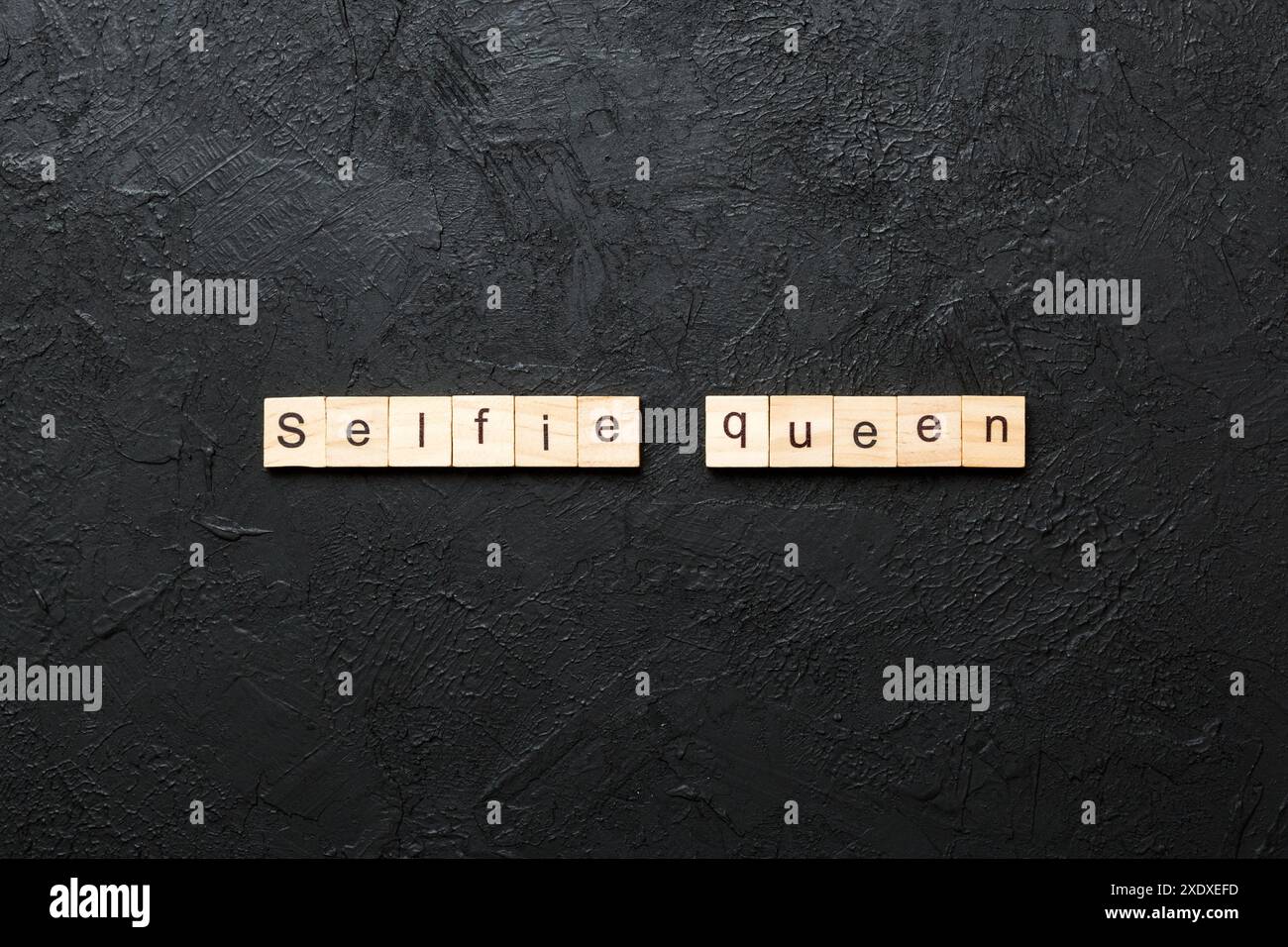 Selfie Queen word written on wood block. Selfie Queen text on cement ...
