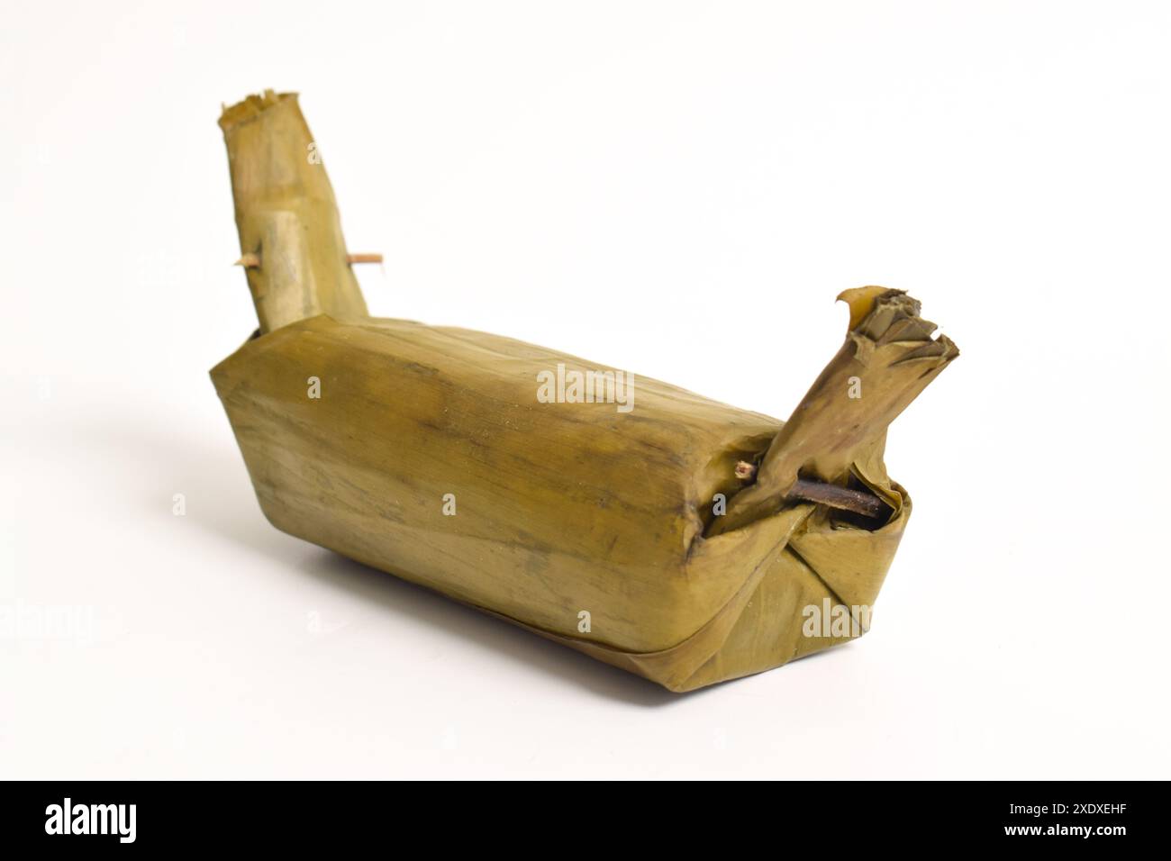 Lontong is an Indonesian dish. Rice is rolled inside a banana leaf and ...