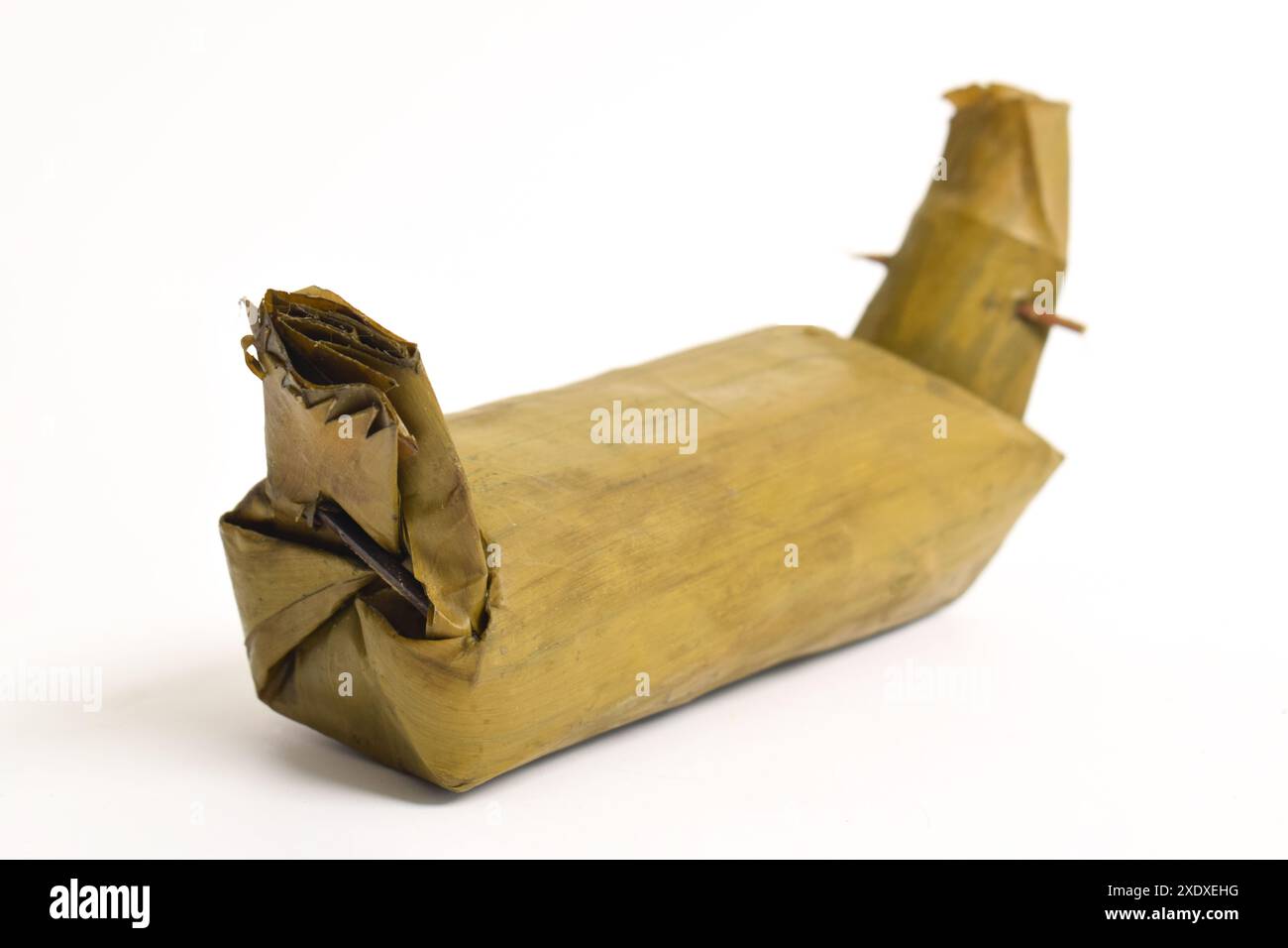 Lontong is an Indonesian dish. Rice is rolled inside a banana leaf and ...