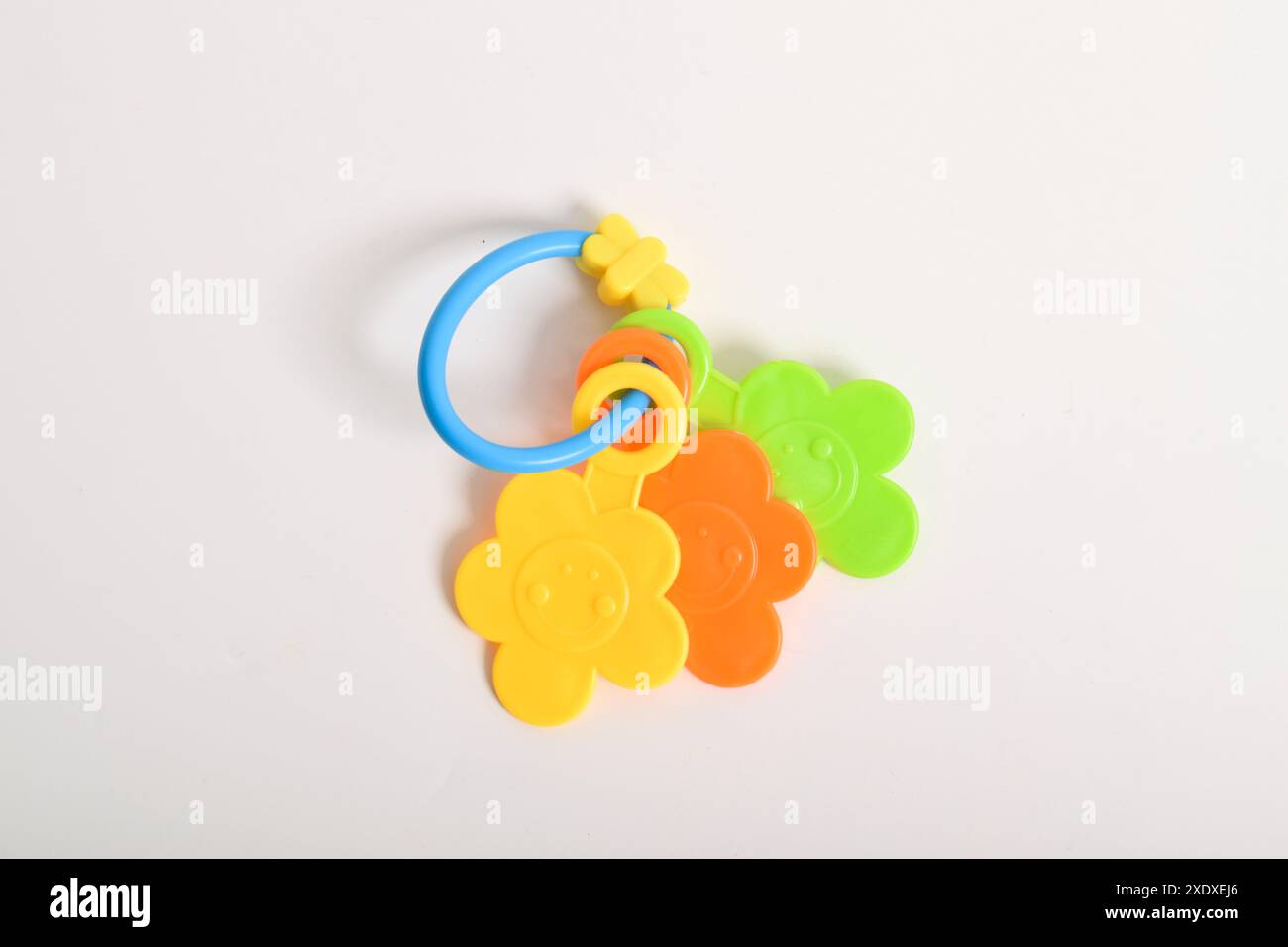 Small baby girl with a toy isolated on white background Stock Photo - Alamy