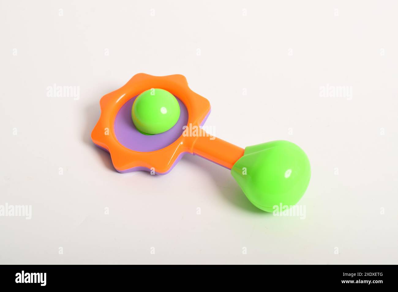 Small baby girl with a toy isolated on white background Stock Photo - Alamy