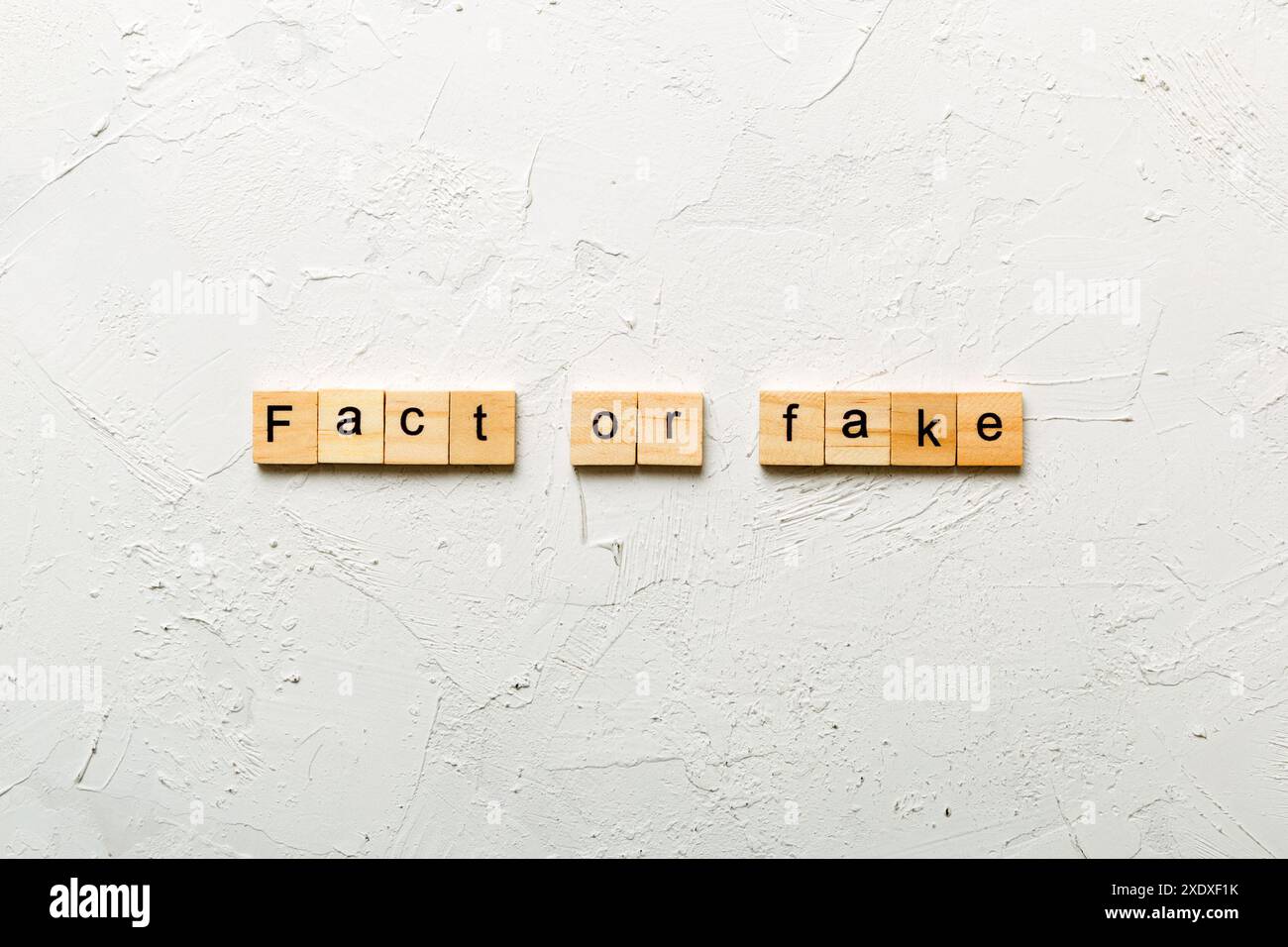fact or fake word written on wood block. fact or fake text on table ...