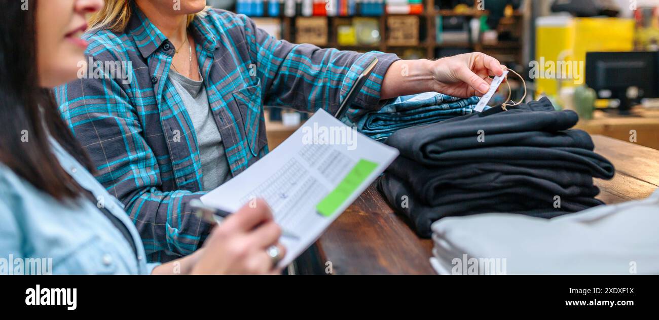 Banner of unrecognizable woman checking price label of black pants on ...