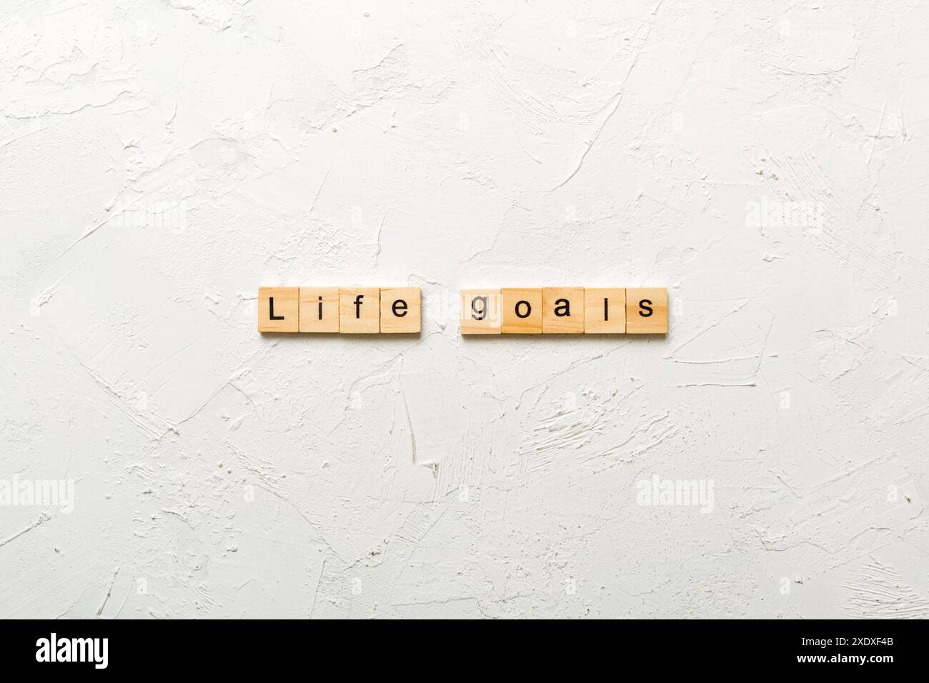 LIFE GOALS word written on wood block. LIFE GOALS text on table ...