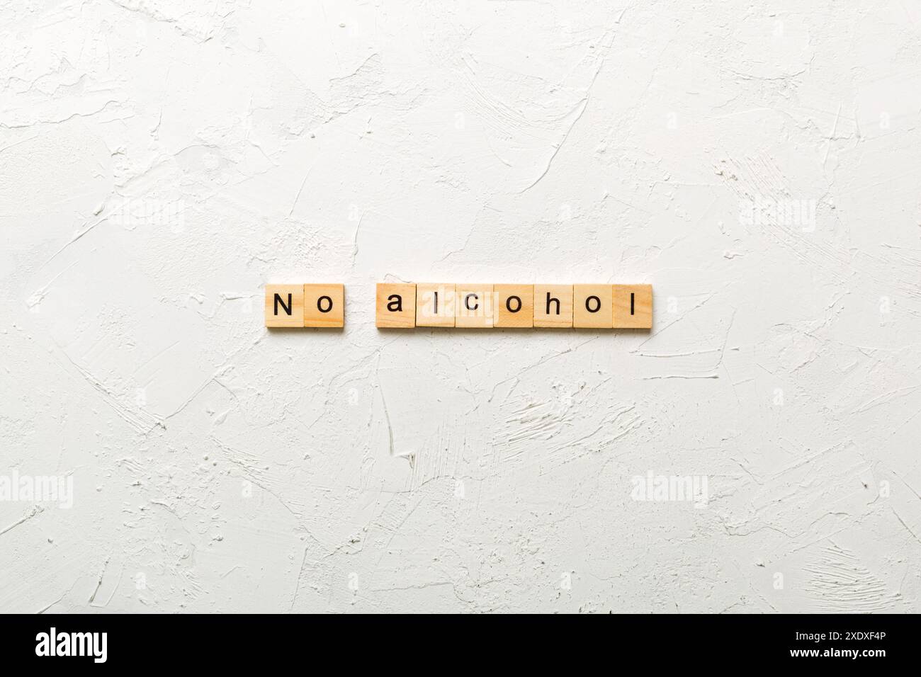No alcohol word written on wood block. No alcohol text on cement table ...
