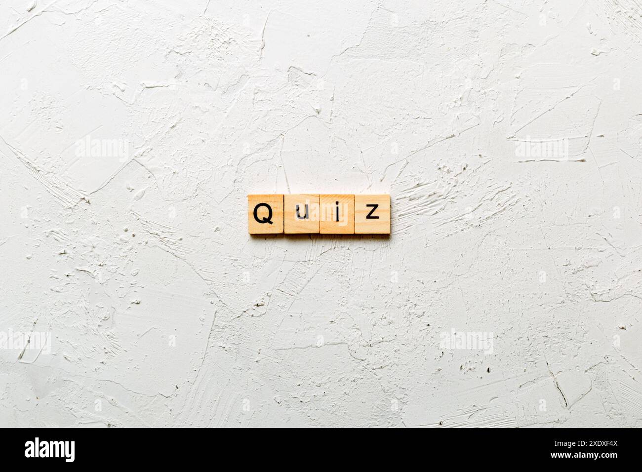 Quiz word written on wood block. Quiz text on cement table for your ...
