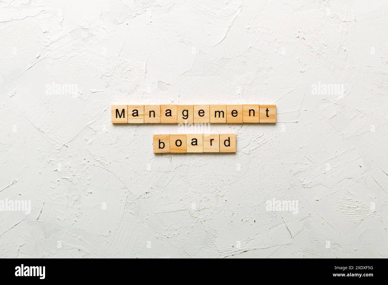 Management board word written on wood block. Management board text on cement table for your ...