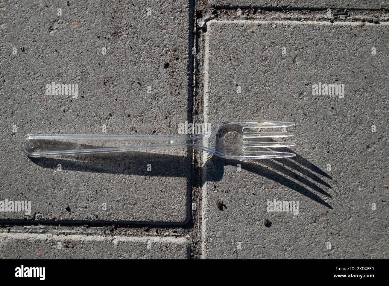 clear plastic fork on ground Stock Photo - Alamy