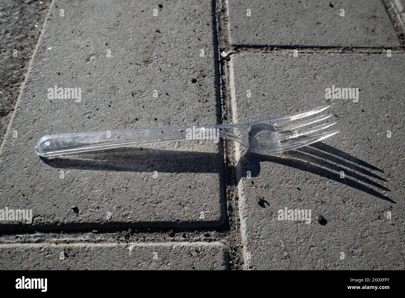 clear plastic fork on ground Stock Photo - Alamy