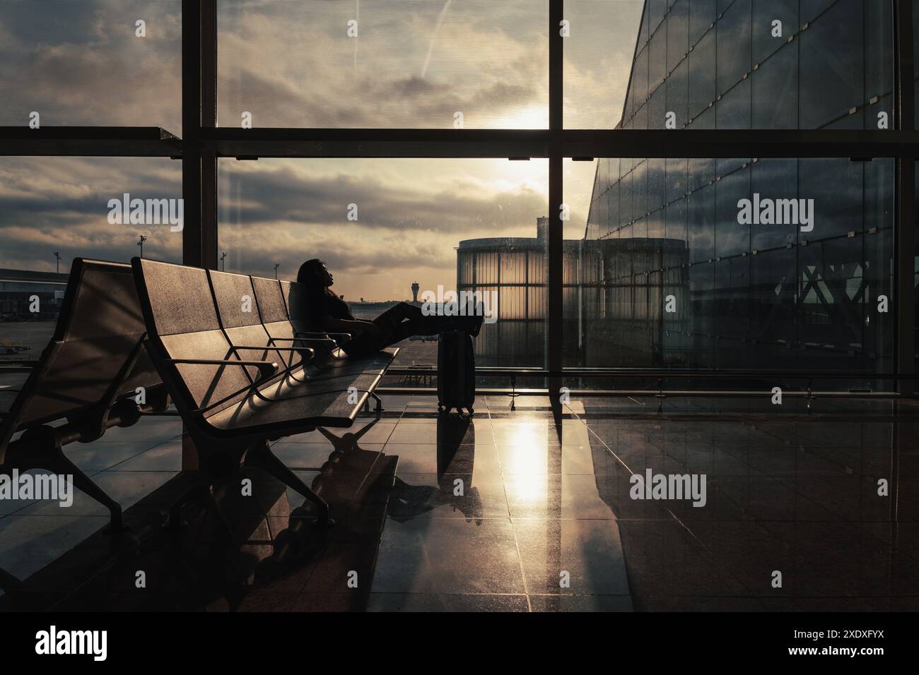 Rays of the sun enter through the window of the boarding area and ...
