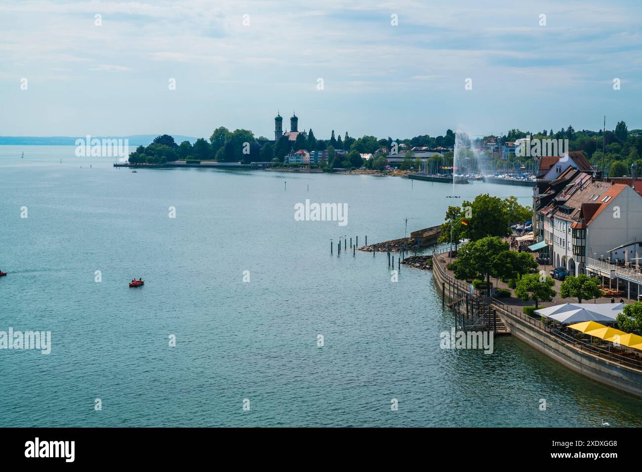 Germany, Friedrichshafen city promenade, houses, fountain and harbor ...