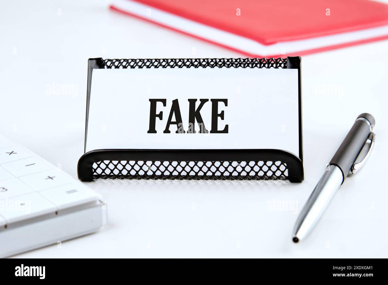 Fake news and digital communication concept. FAKE written on a business ...