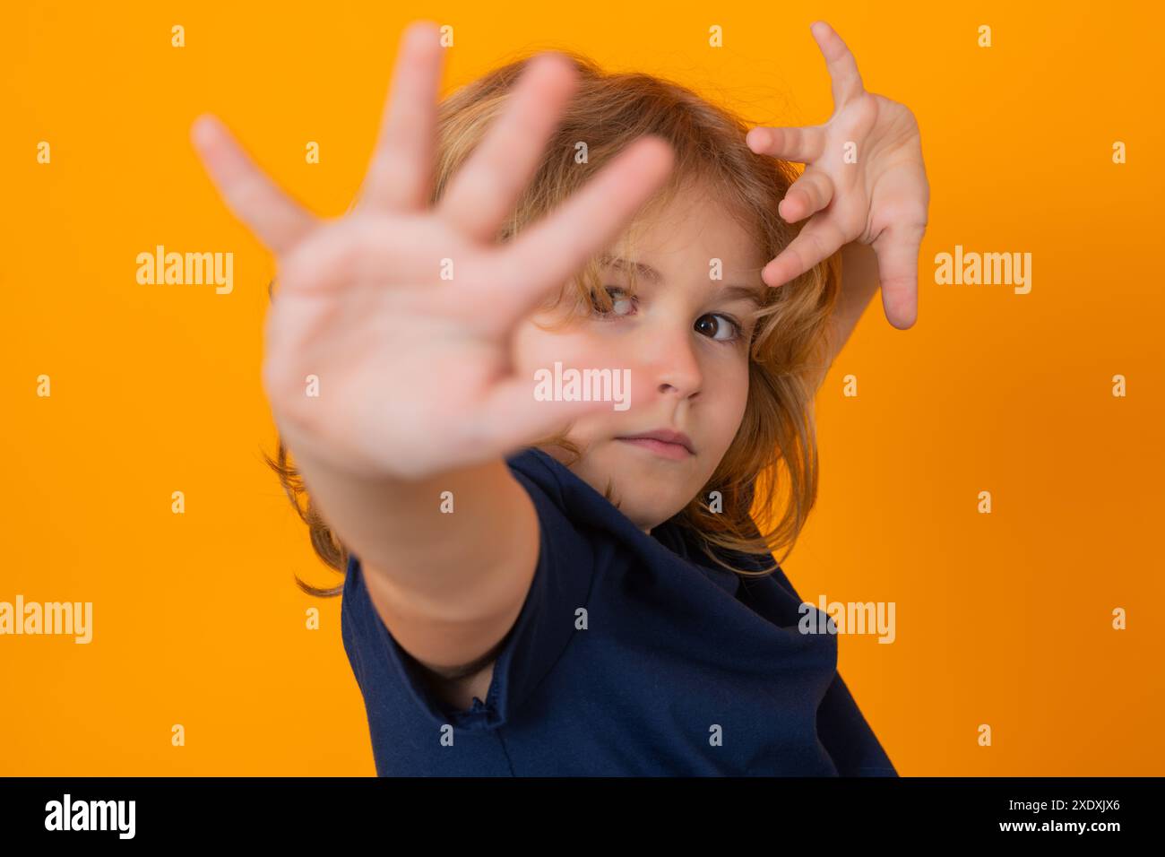 Child making stop gesture on isolated studio background. Little boy ...