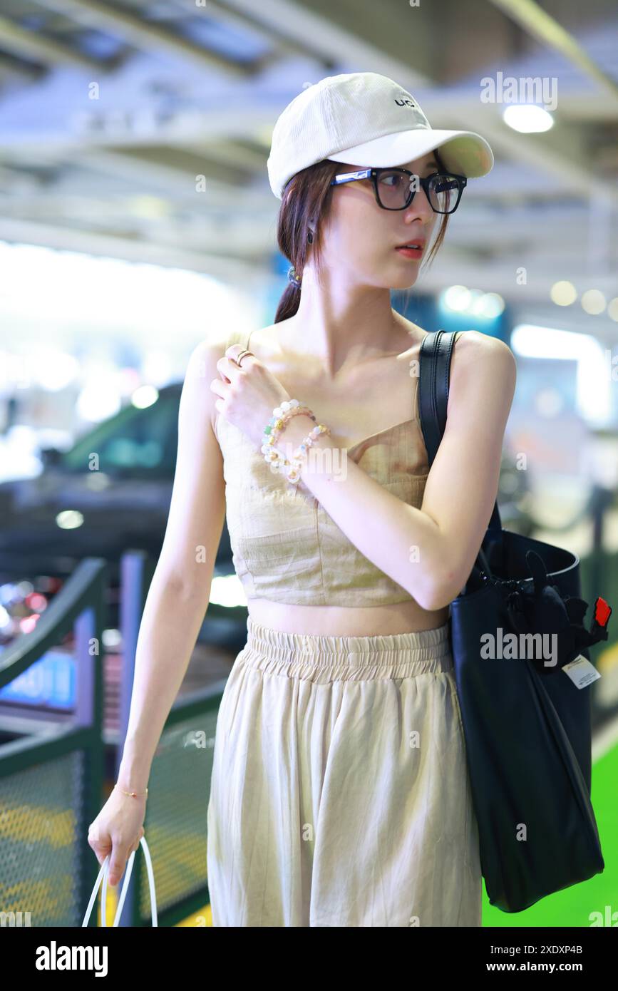 Chinese actress Wan Peng appears at the airport in Shanghai, China ...