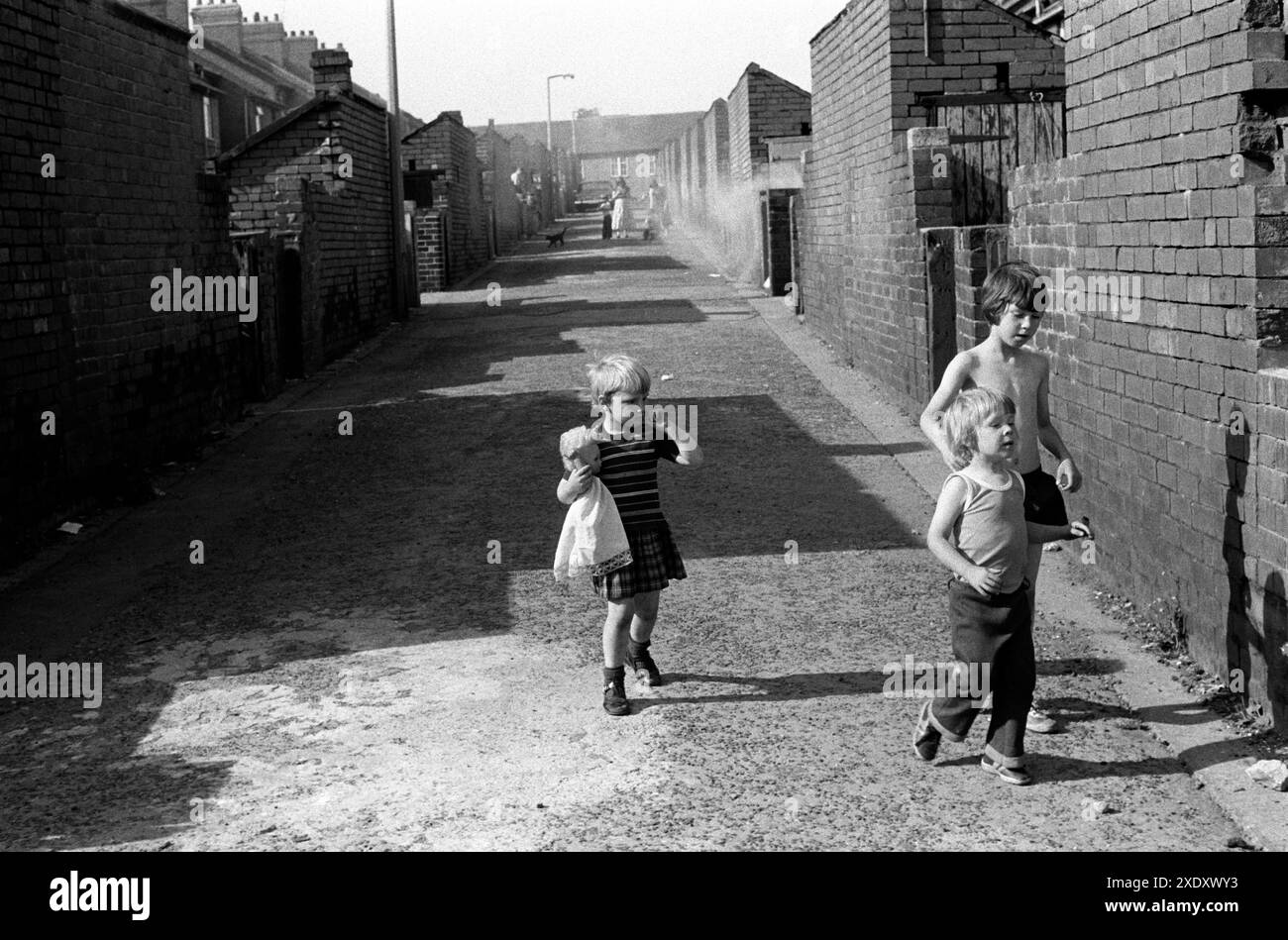 Kids playing in the 'back lane' or 'back alley' a traffic free road ...