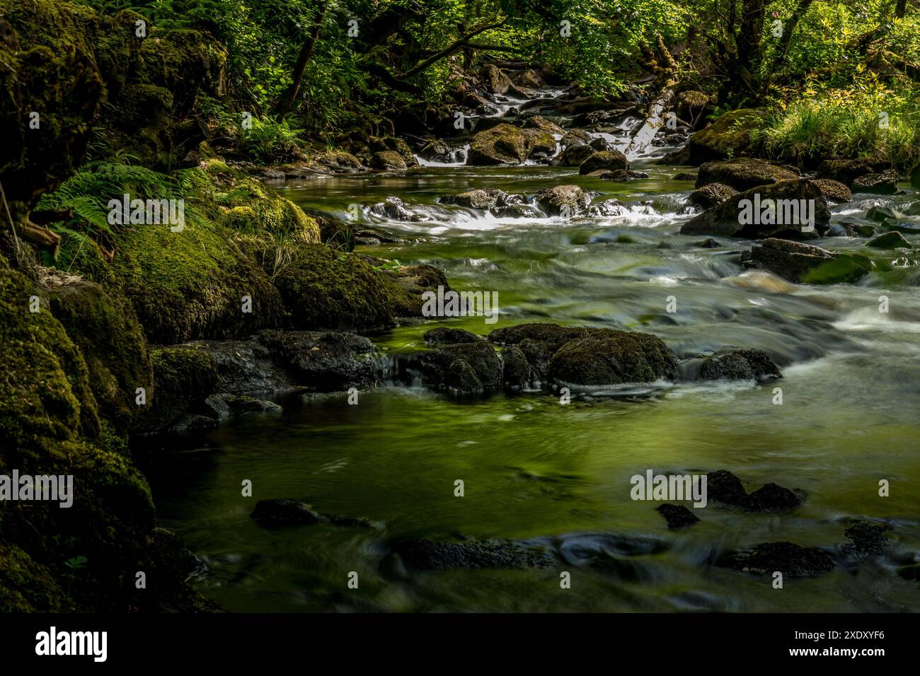 Smooth water, slow shutter speed of beautiful river over rocks in the ...