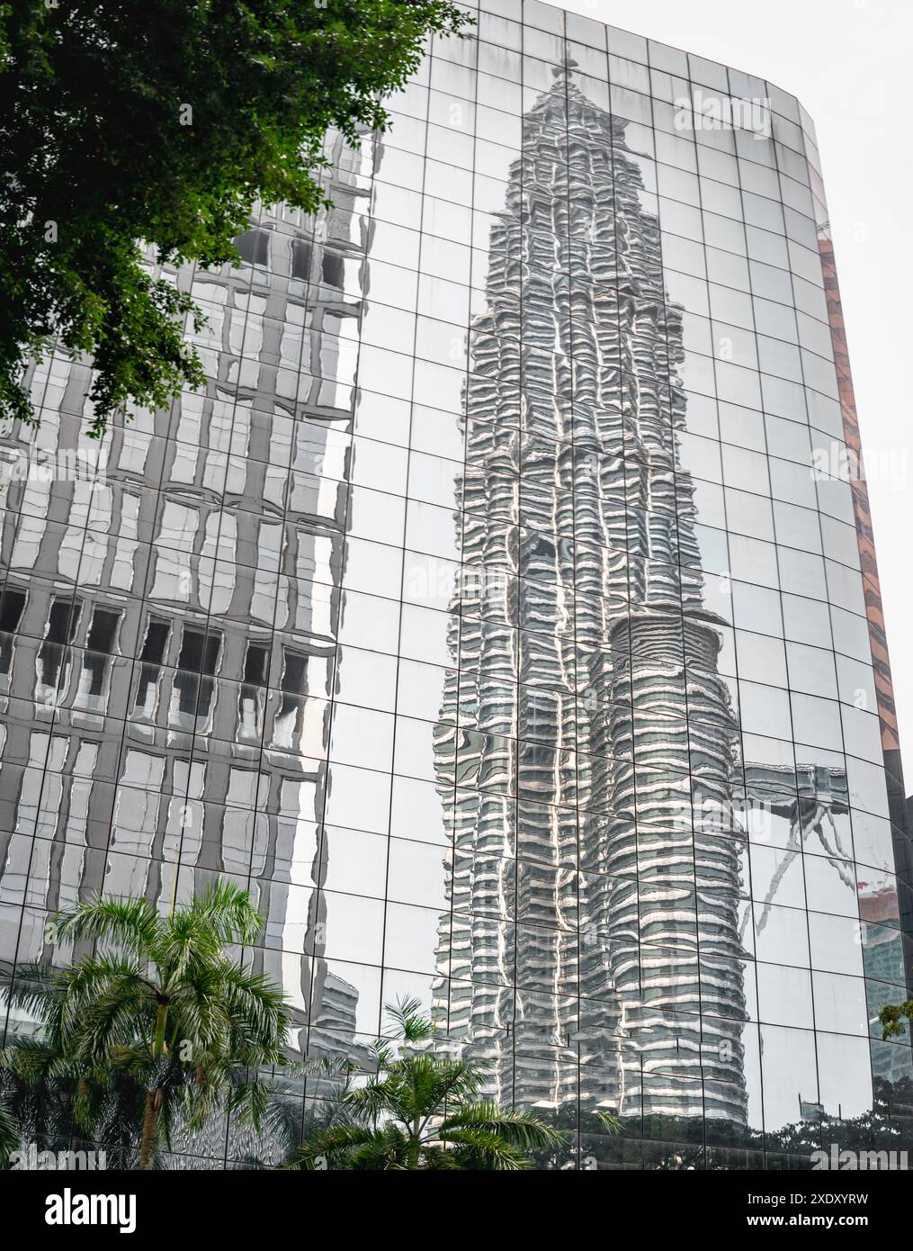 One of the iconic towers is reflected from the shiny surface of a ...