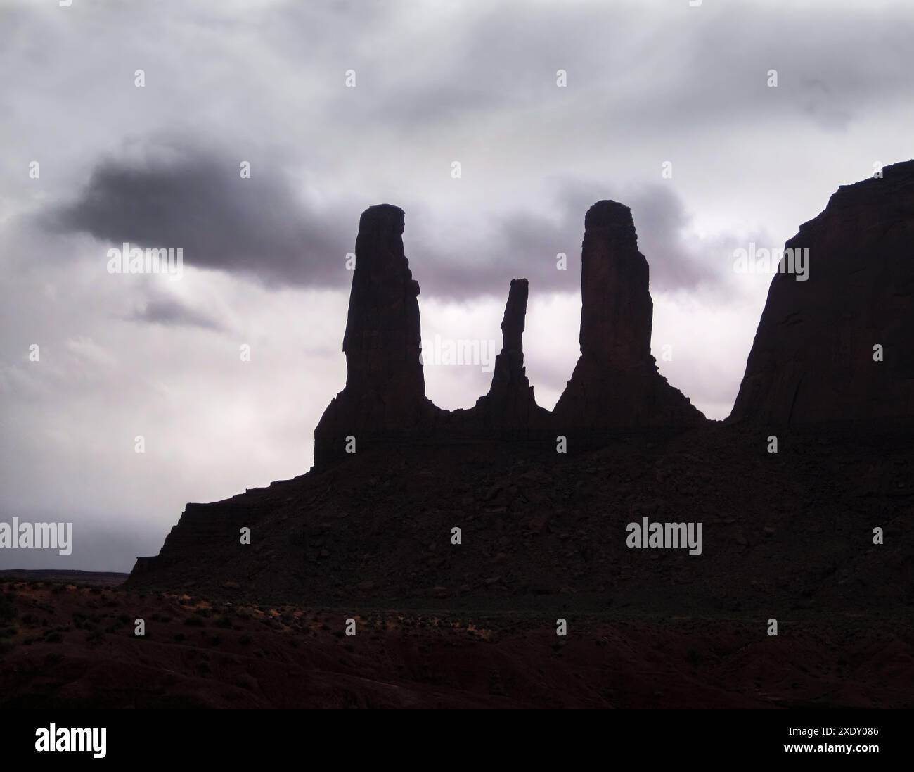 Three Sisters rock formation in Monument Valley silhouetted against the ...