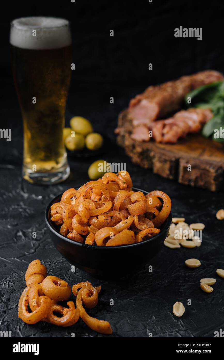 Pork ear snack in the bowl close up with beer in a glass Stock Photo ...