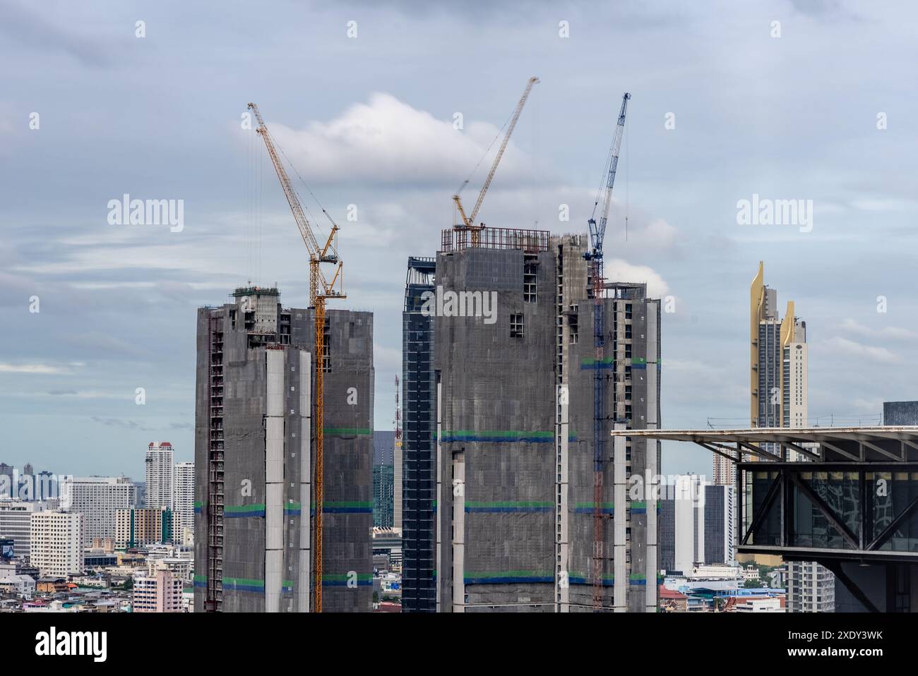 Timelapse view of big construction cranes working on top of high-rise ...