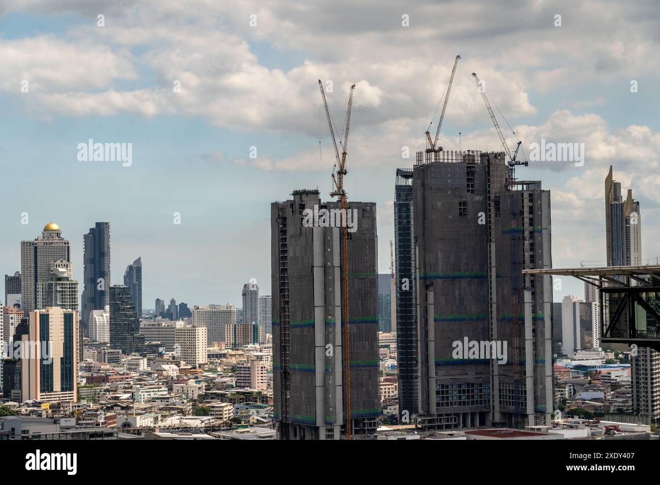 Timelapse view of big construction cranes working on top of high-rise ...