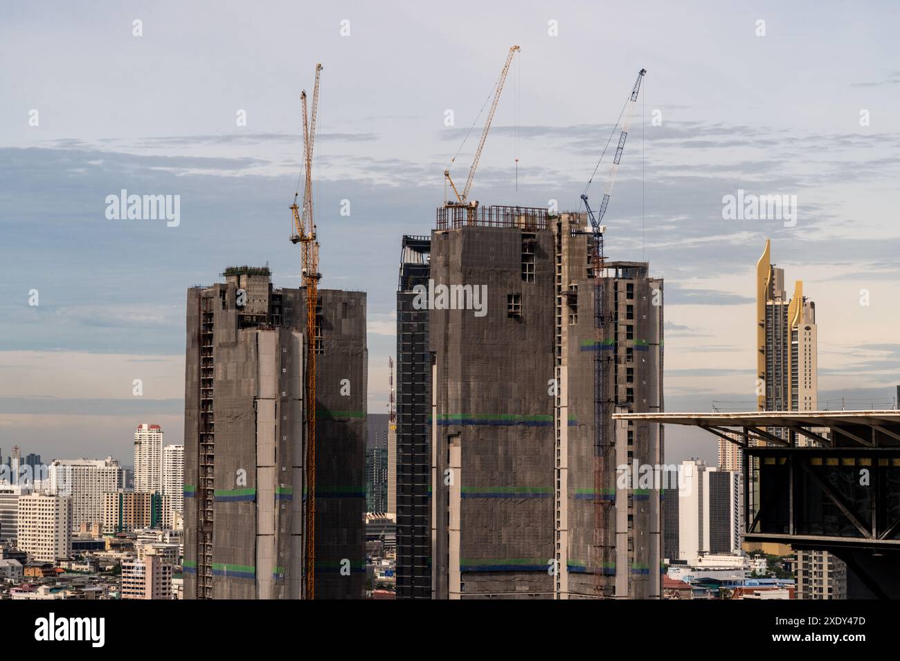 Timelapse view of big construction cranes working on top of high-rise ...