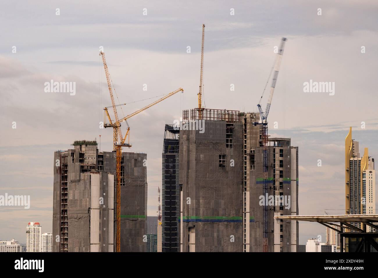 Timelapse view of big construction cranes working on top of high-rise ...
