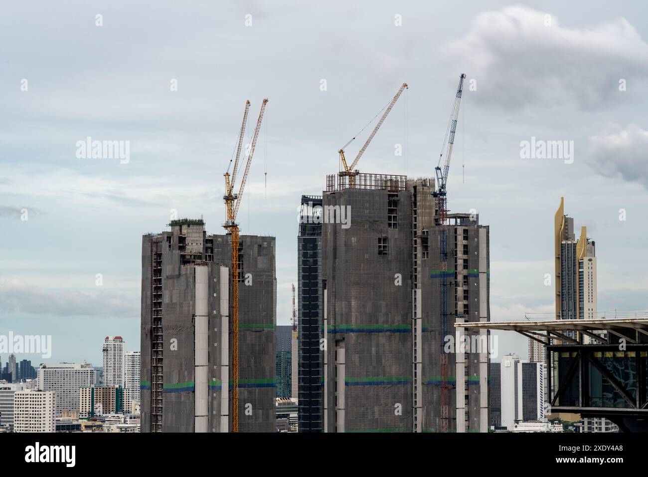 Timelapse view of big construction cranes working on top of high-rise ...